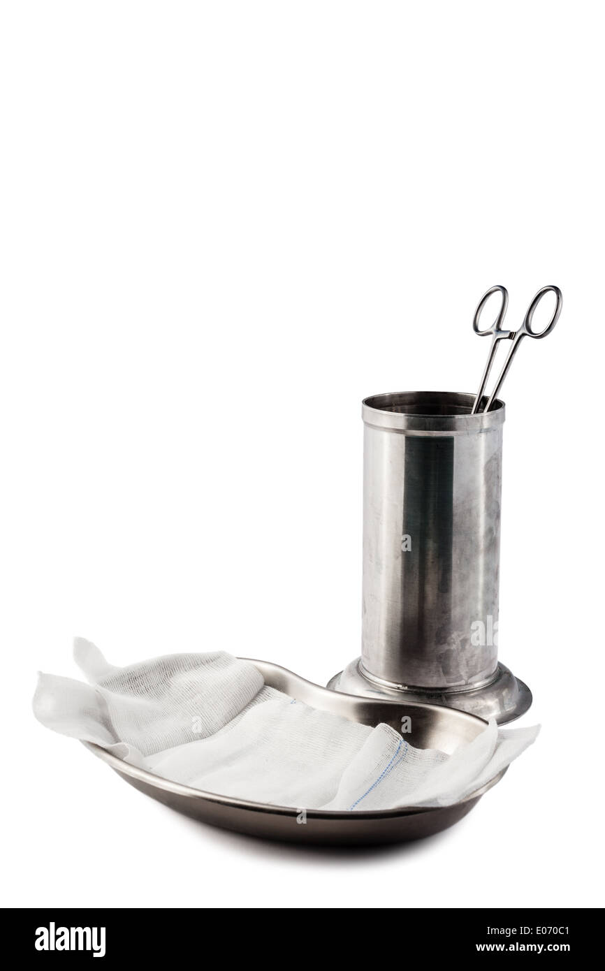 a surgical tray with some gauze and a surgical container with a pair of ...