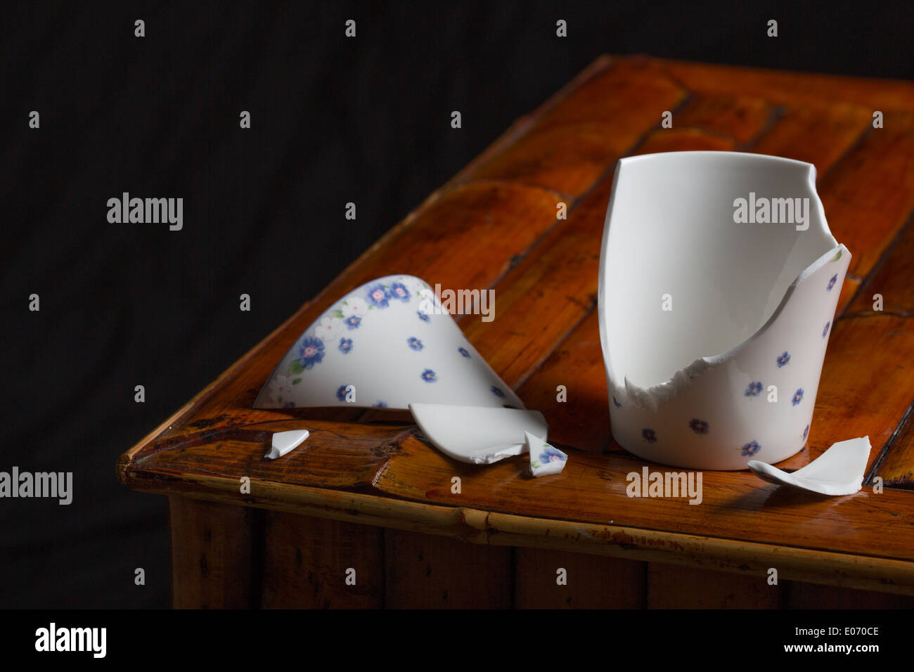 A broken tea cup with pieces Stock Photo - Alamy