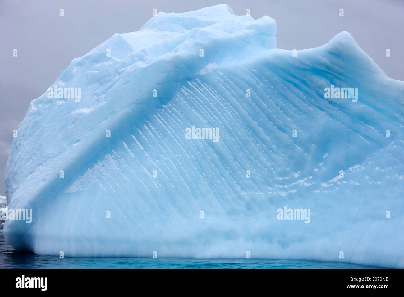 iceberg showing straight striped lines and water line erosion near ...
