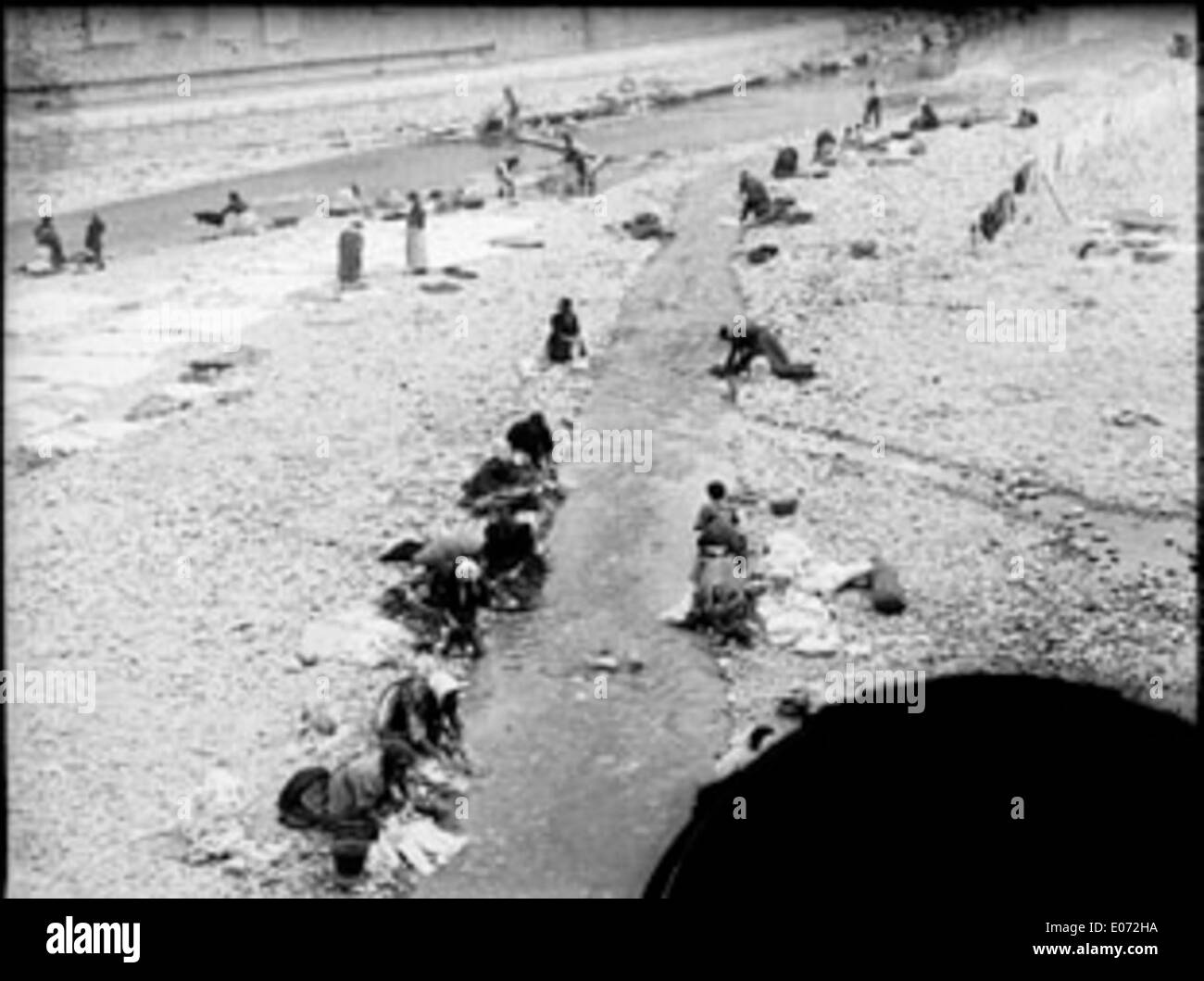 An early 20th-century photograph of women washing clothes at the banks ...