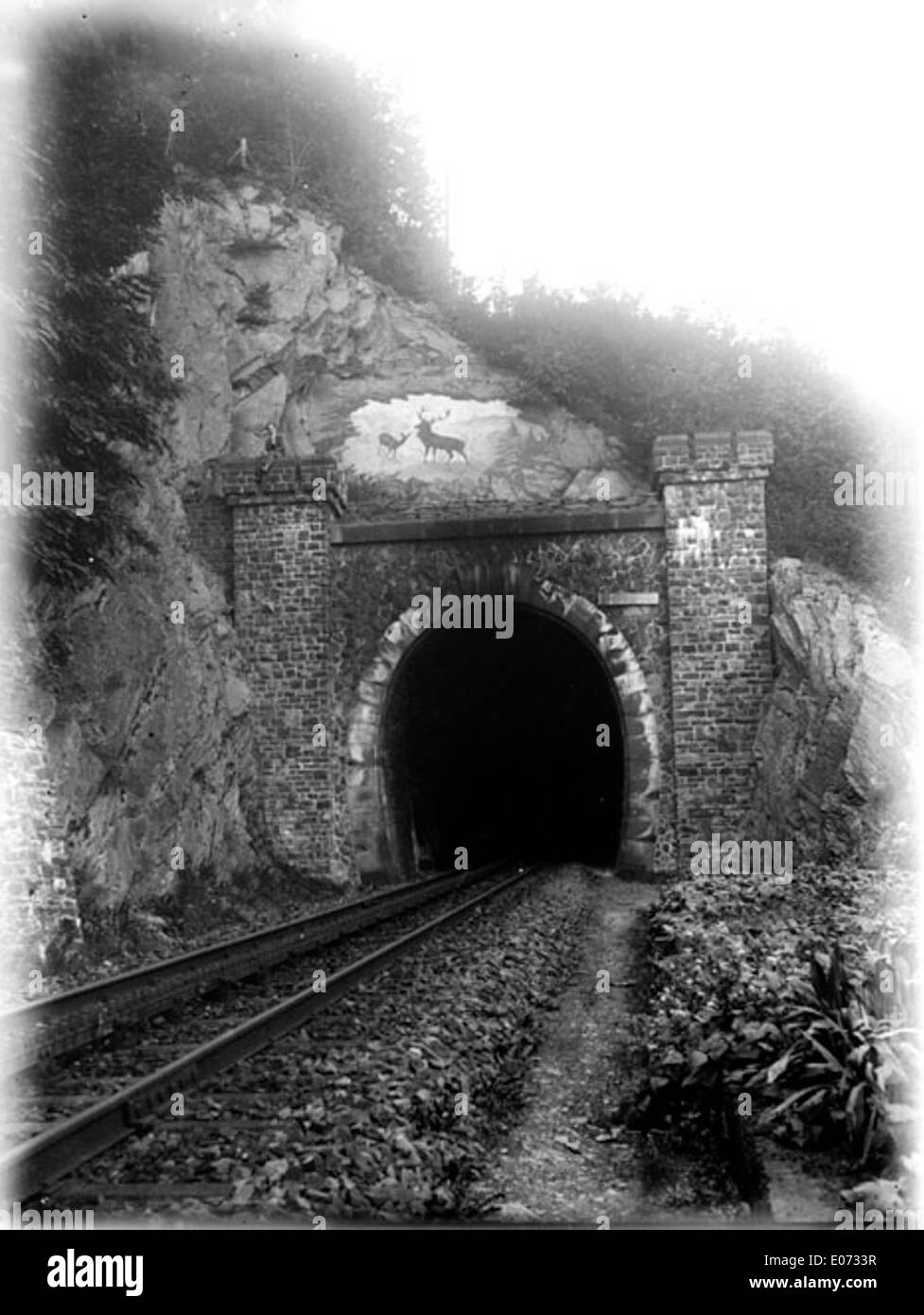 This image depicts the entrance of a railway tunnel dug through solid ...