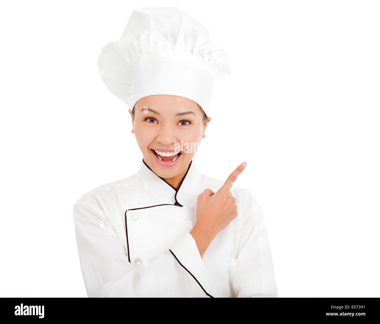 Portrait of young woman chef pointing direction Stock Photo - Alamy