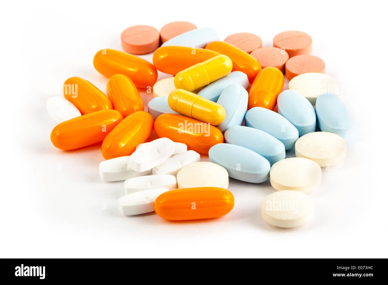 a heap of various types of pills and tablets isolated over white Stock ...