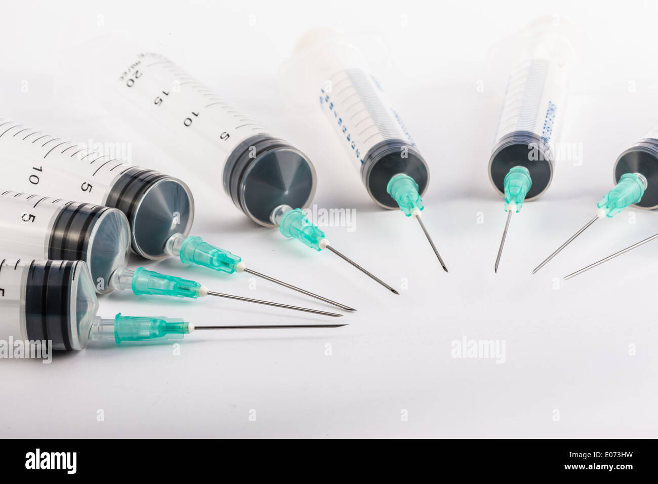 eight syringes with the needles converging to a point Stock Photo - Alamy