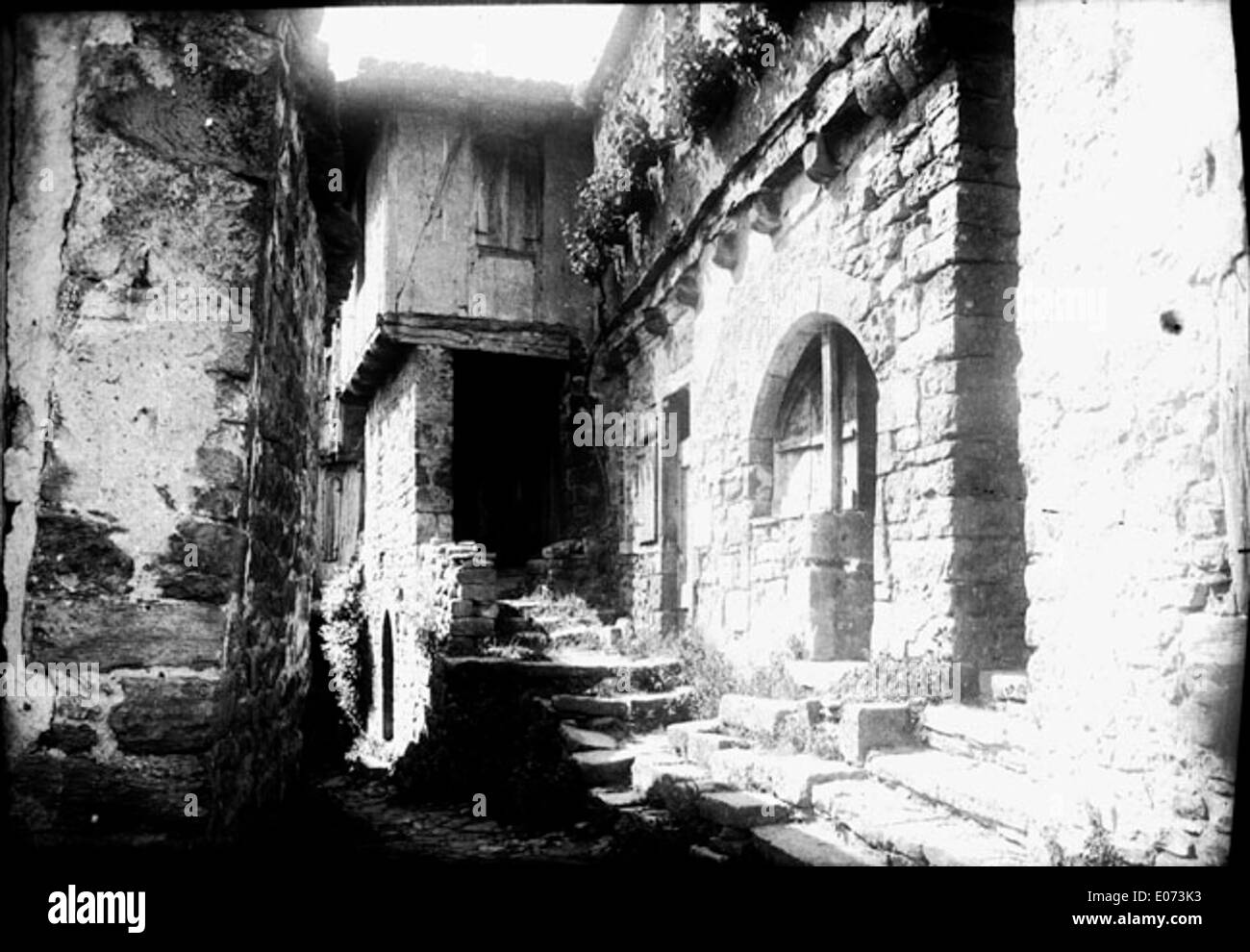 This image showcases a narrow alley and old houses in a medieval ...