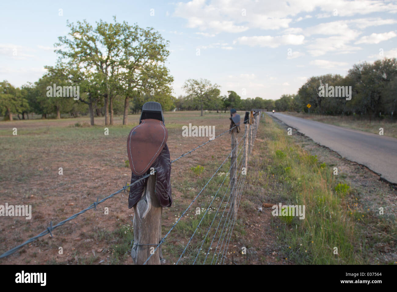 Cowboy boots on fence hi-res stock photography and images - Alamy
