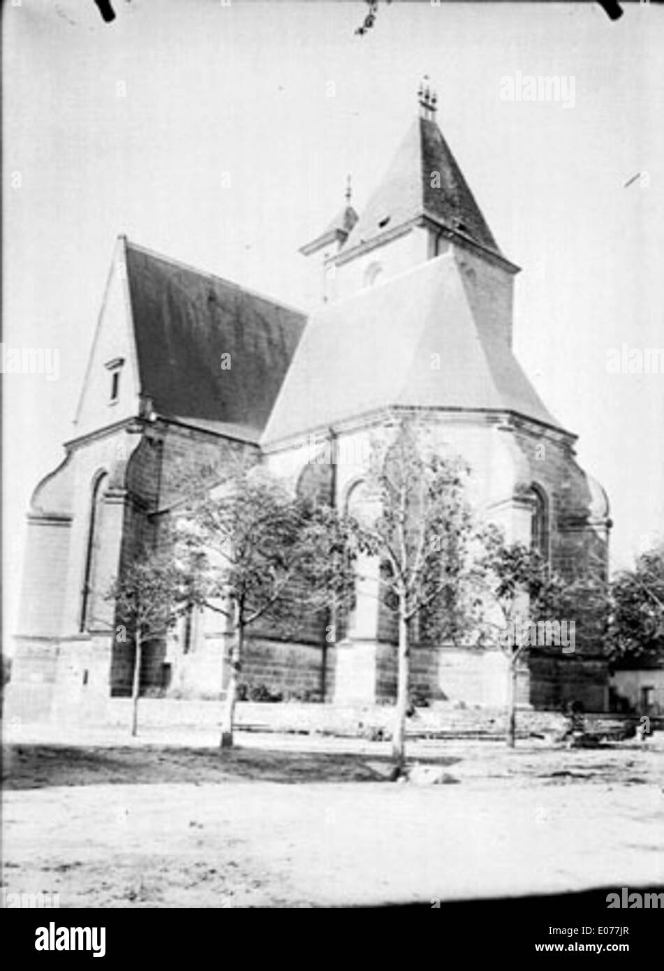 This photograph shows the chevet of the church in Assier, captured in ...