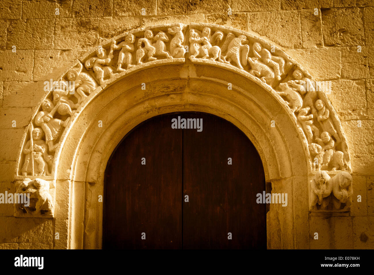 an ancient and complex bas relief on the top of a church door Stock ...