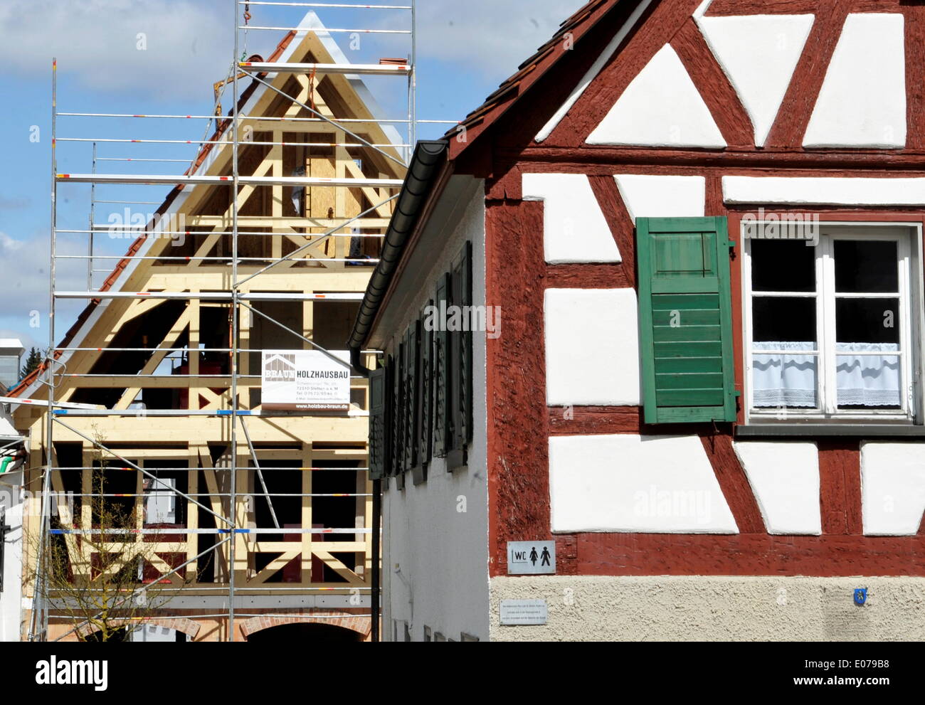 New constructed frame house in front of a historical frame house in the ...
