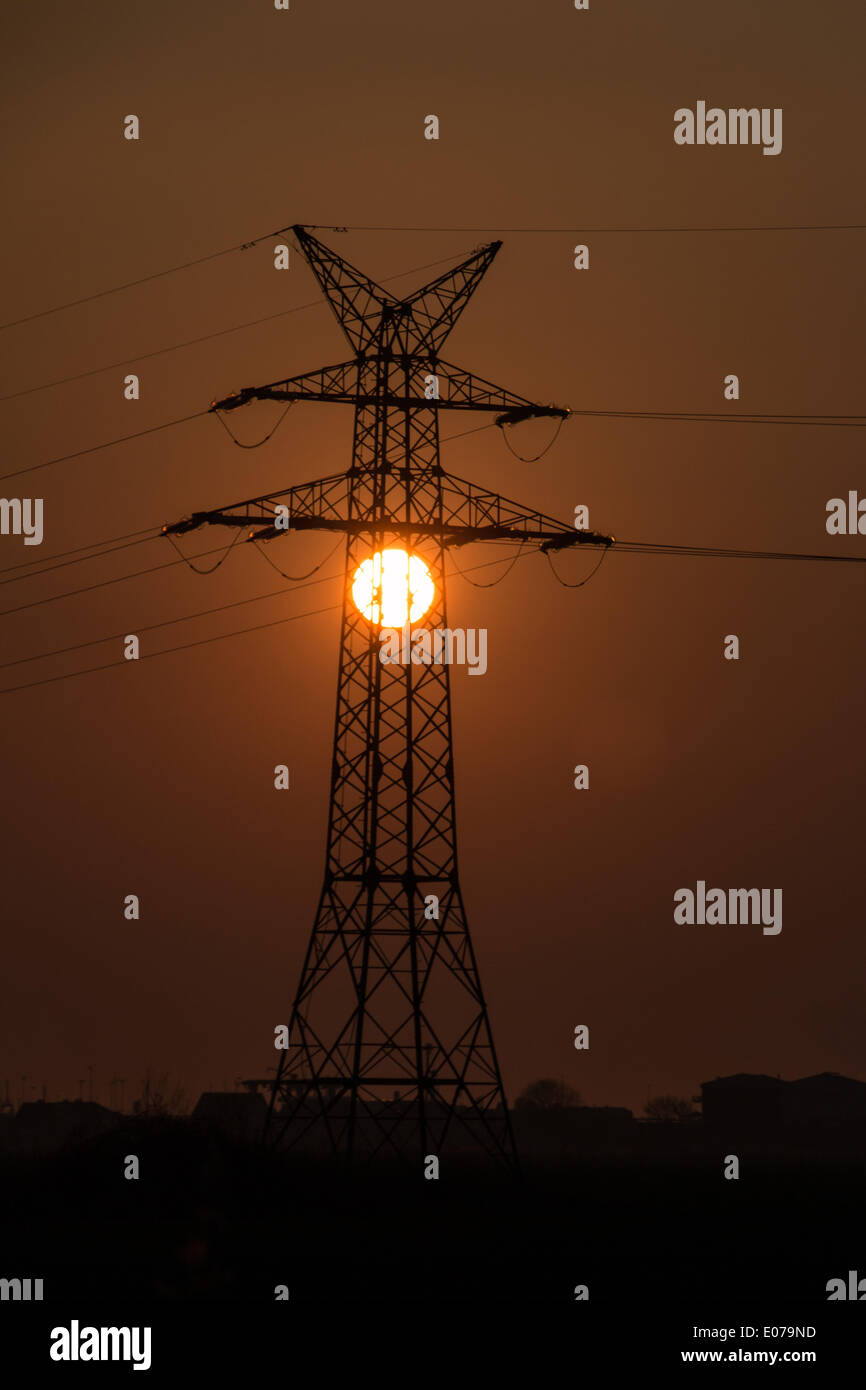 High Voltage Mast With Sun Stock Photo - Alamy