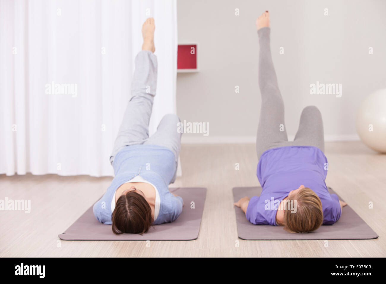 Women doing Pilates exercises, feet up Stock Photo - Alamy