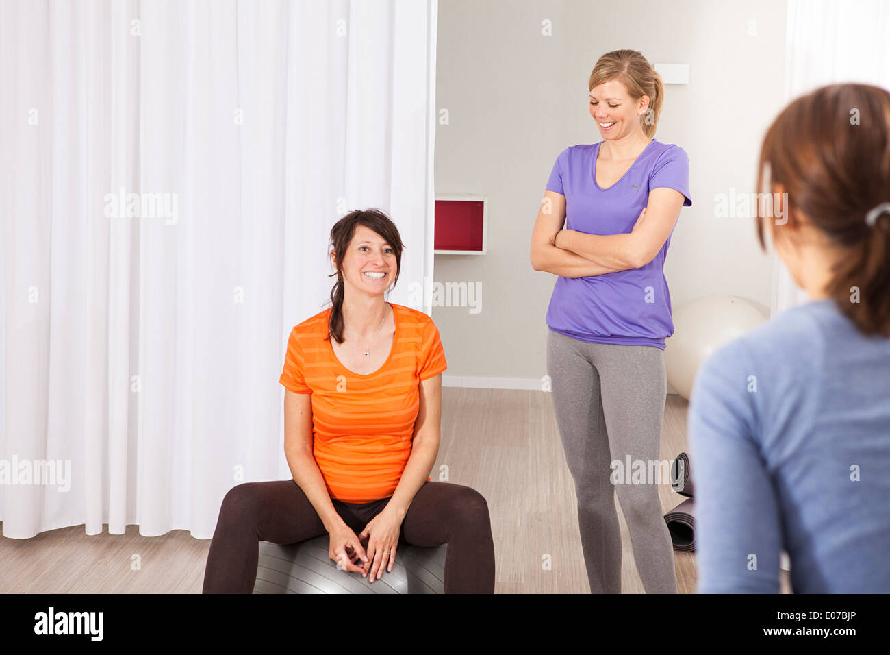 Three women taking a break in gym Stock Photo - Alamy