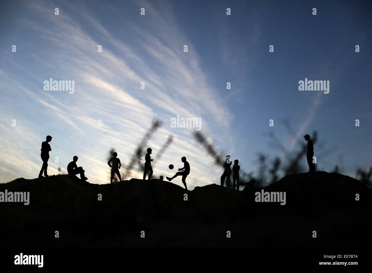 Gaza. 4th May, 2014. Palestinian boys play football at sunset in the ...
