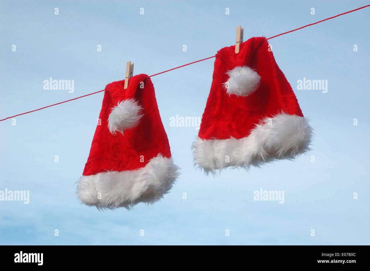 Illustration - Two Santa Claus hats are pictured on a clothesline, 28 ...