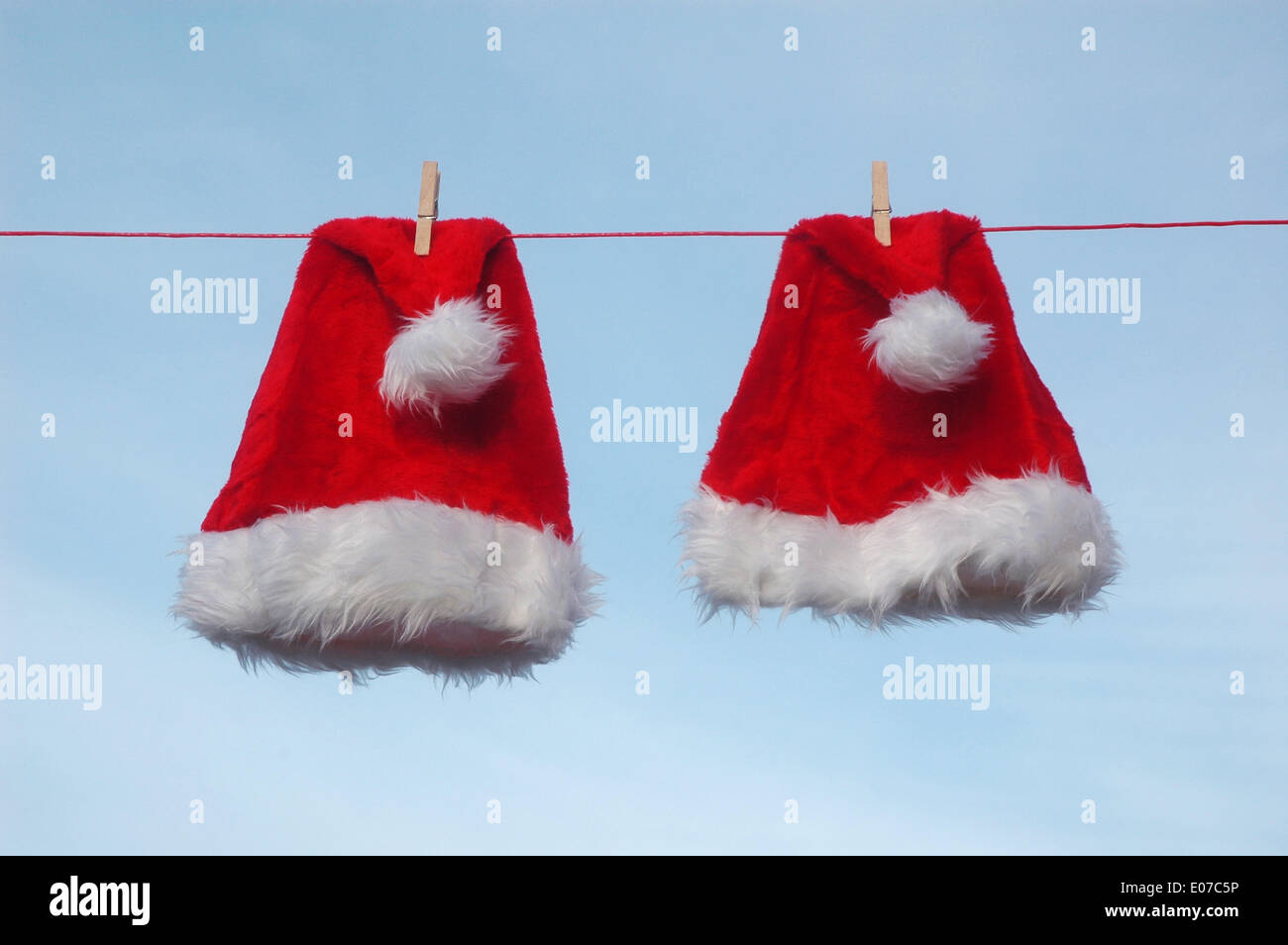 Illustration - Two Santa hats hang on a clothesline in Germany, 28 ...
