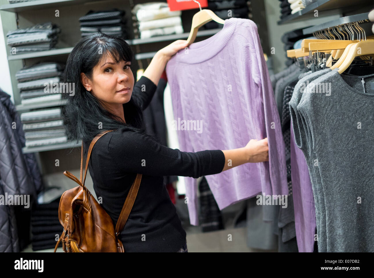 Woman in clothes store hi-res stock photography and images - Alamy