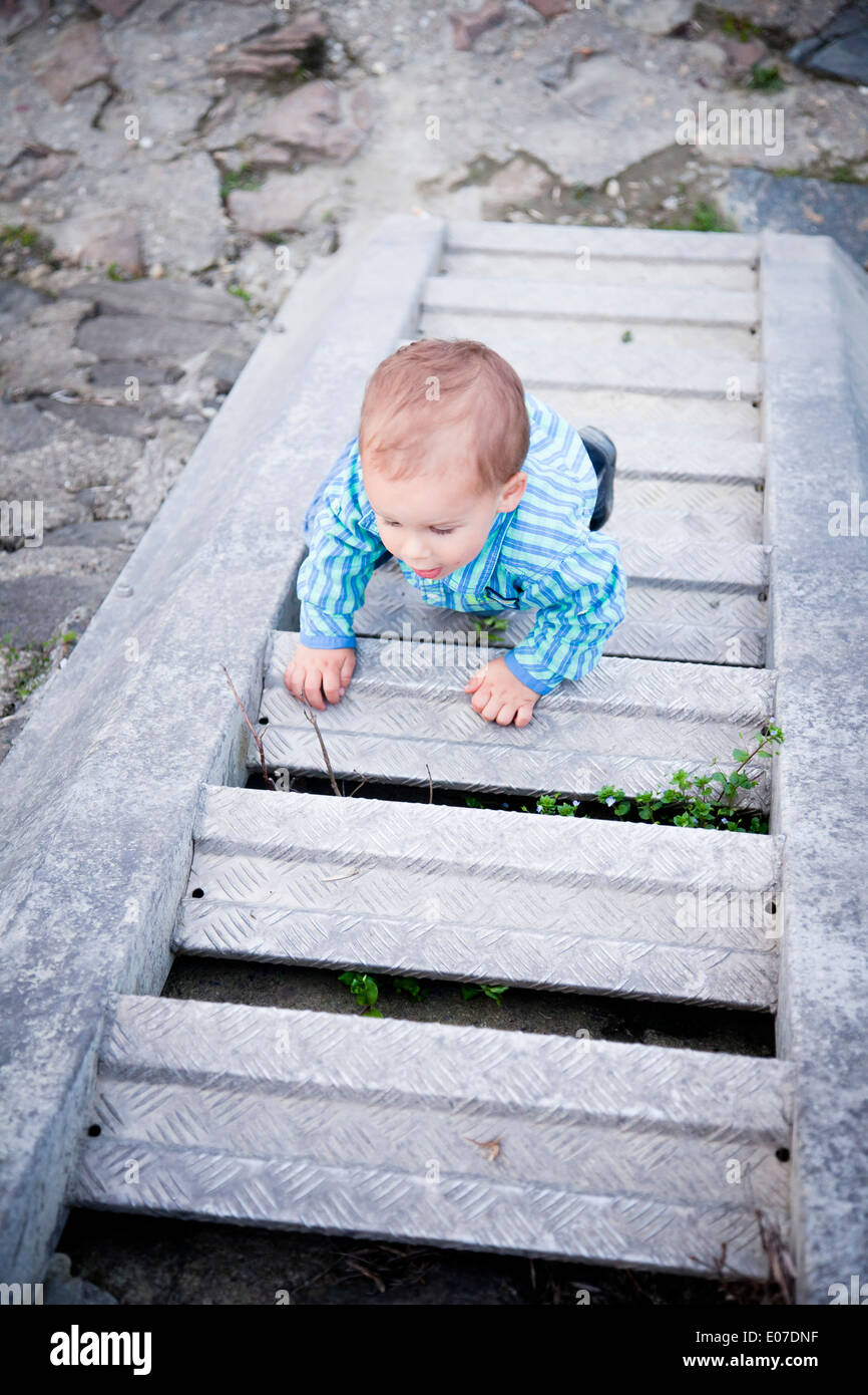 Toddler boy crawling upstairs, Austria Stock Photo - Alamy