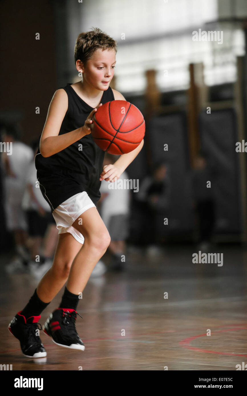 Boy playing basketball in a hall Stock Photo - Alamy