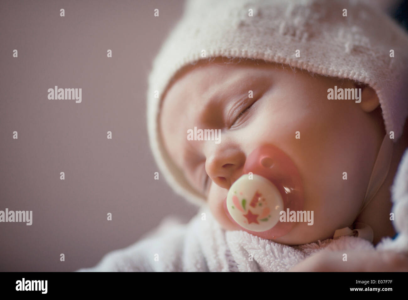 Baby girl sleeping with pacifier in mouth Stock Photo - Alamy