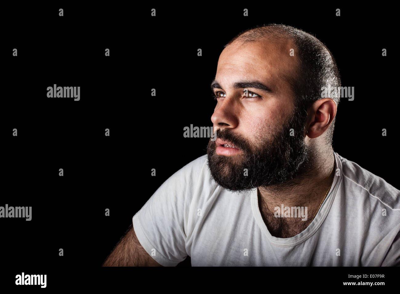 a masculine bearded man isolated over a black background Stock Photo ...
