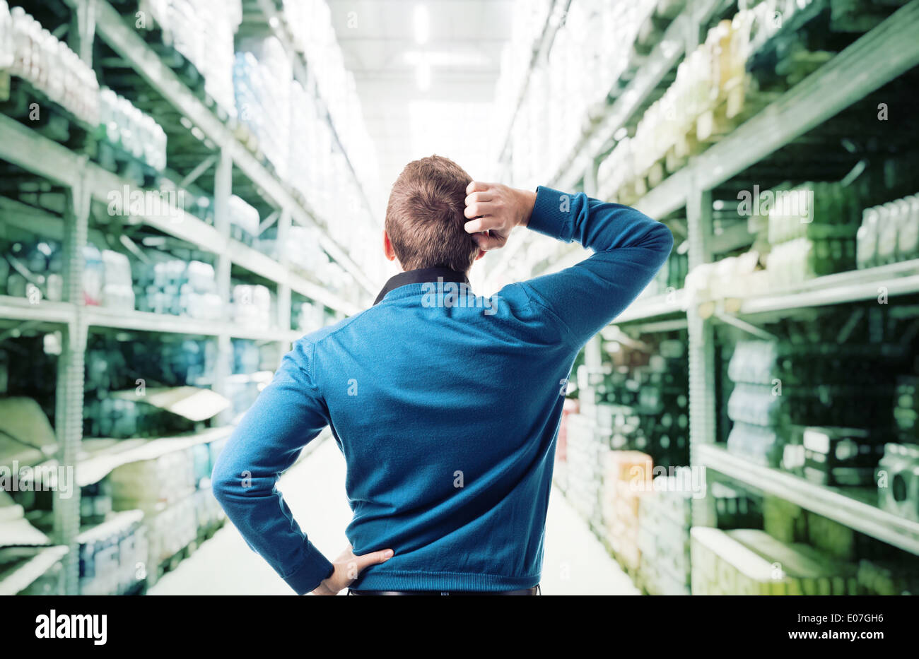 thinking man and shop warehouse background Stock Photo - Alamy