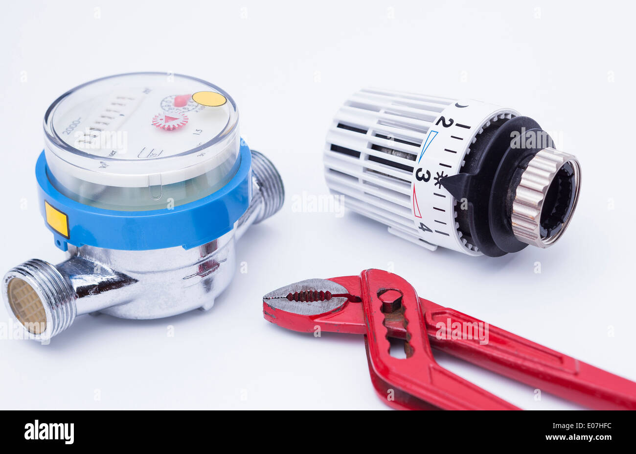 Pipe wrench, water counter and thermostat Stock Photo - Alamy