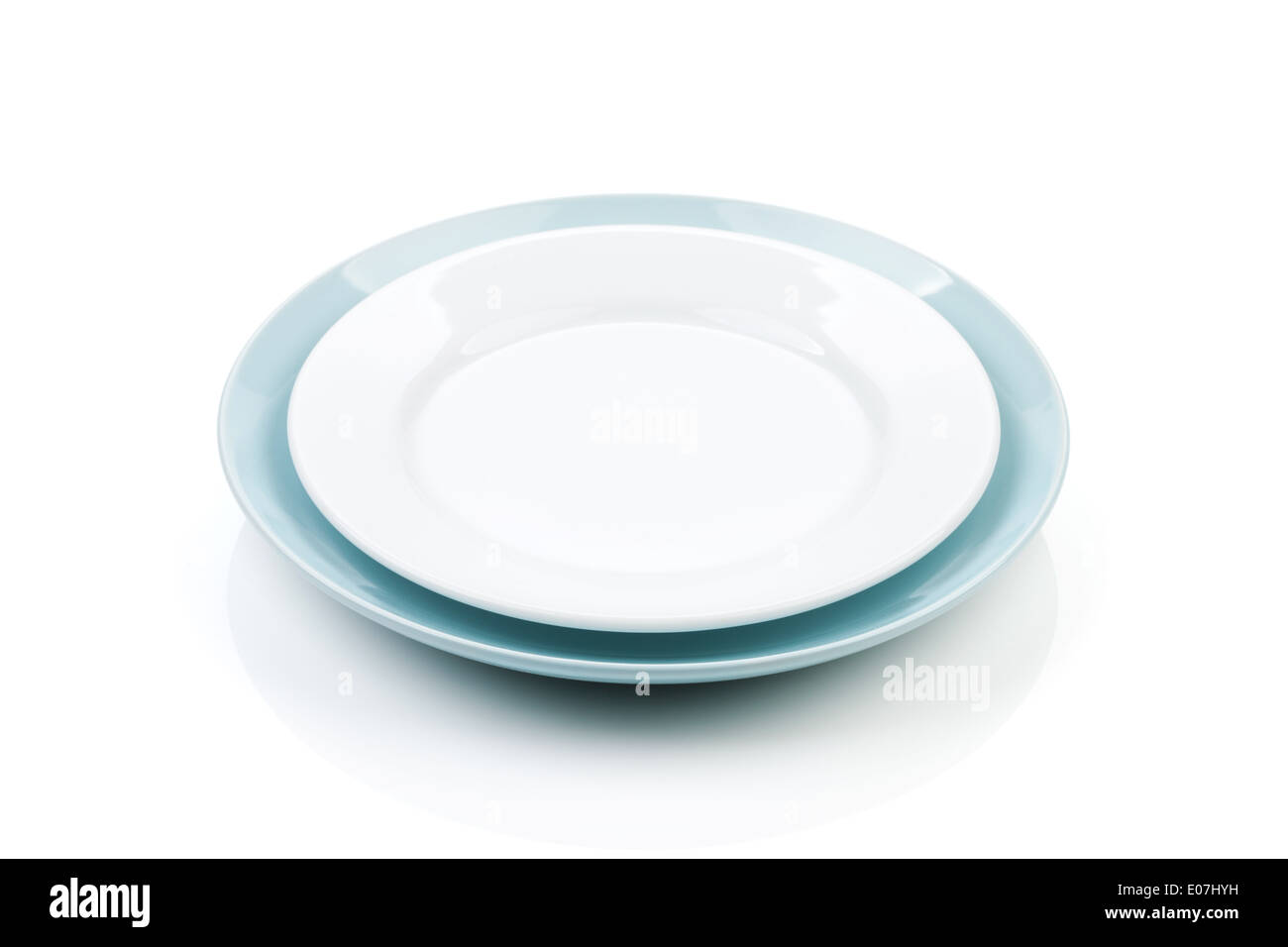 Empty plates. Isolated on white background Stock Photo - Alamy