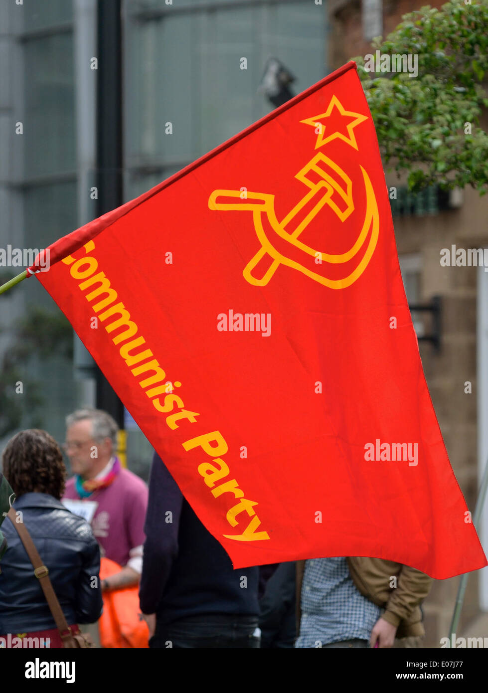 Manchester, UK. 5th May 2014. A protester hold a communist flag during ...