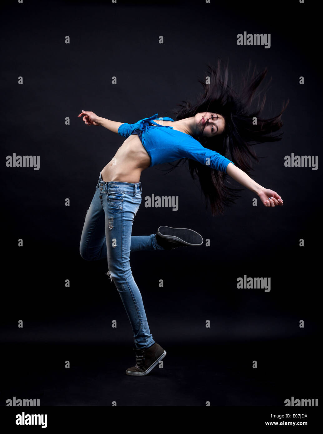 Young beautiful dancer posing on studio background Stock Photo - Alamy
