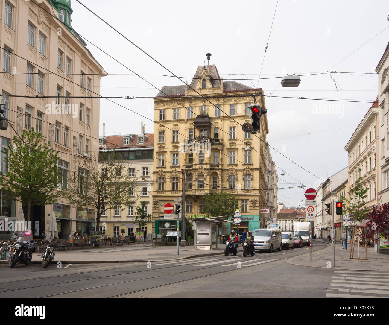 Street, buildings, traffic, and tram tracks, red light at an ...