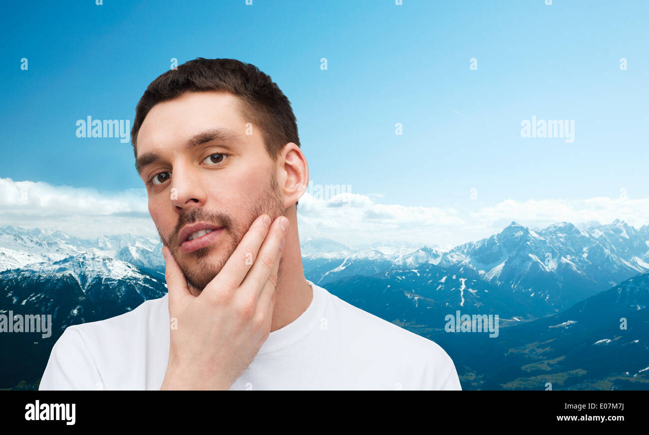 beautiful calm man touching his face Stock Photo - Alamy