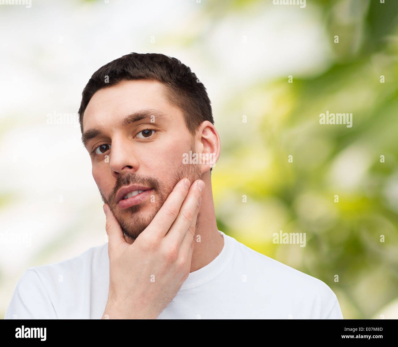 beautiful calm man touching his face Stock Photo - Alamy