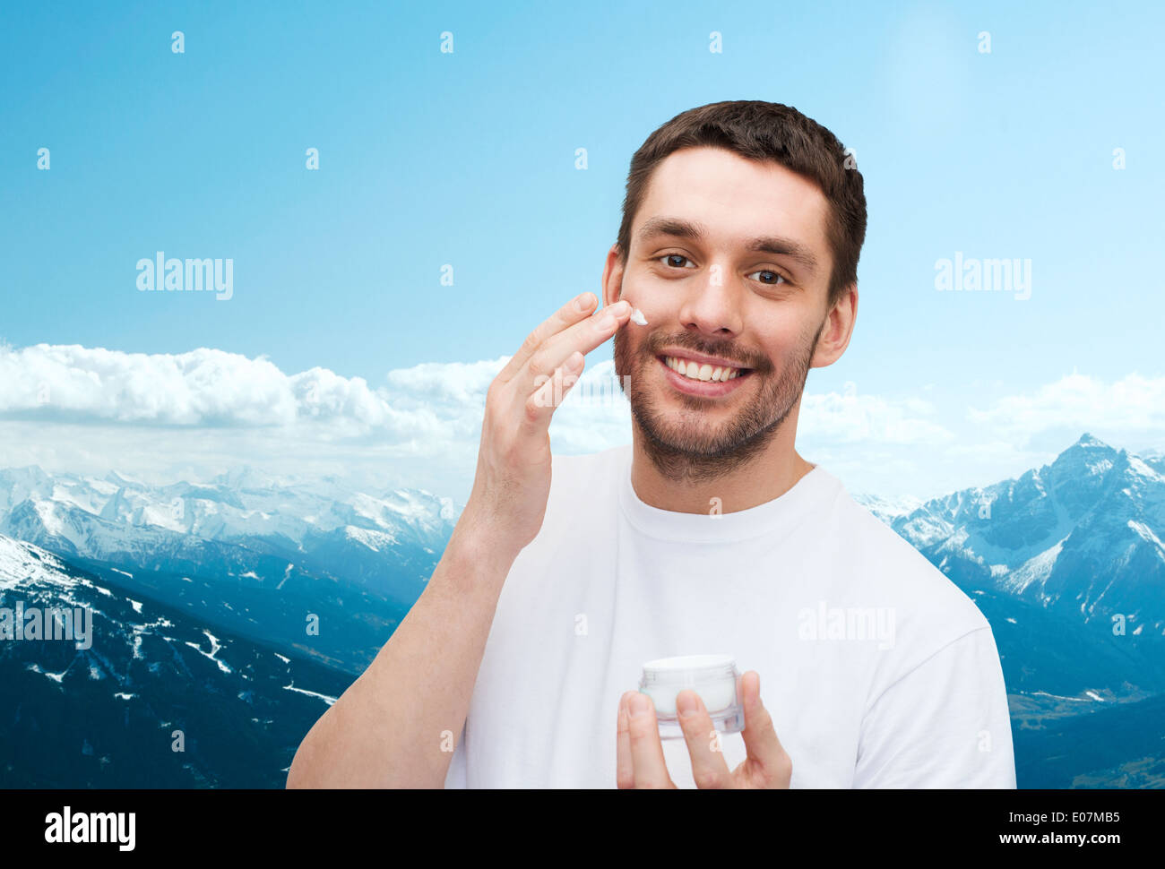 beautiful smiling man applyin cream Stock Photo - Alamy