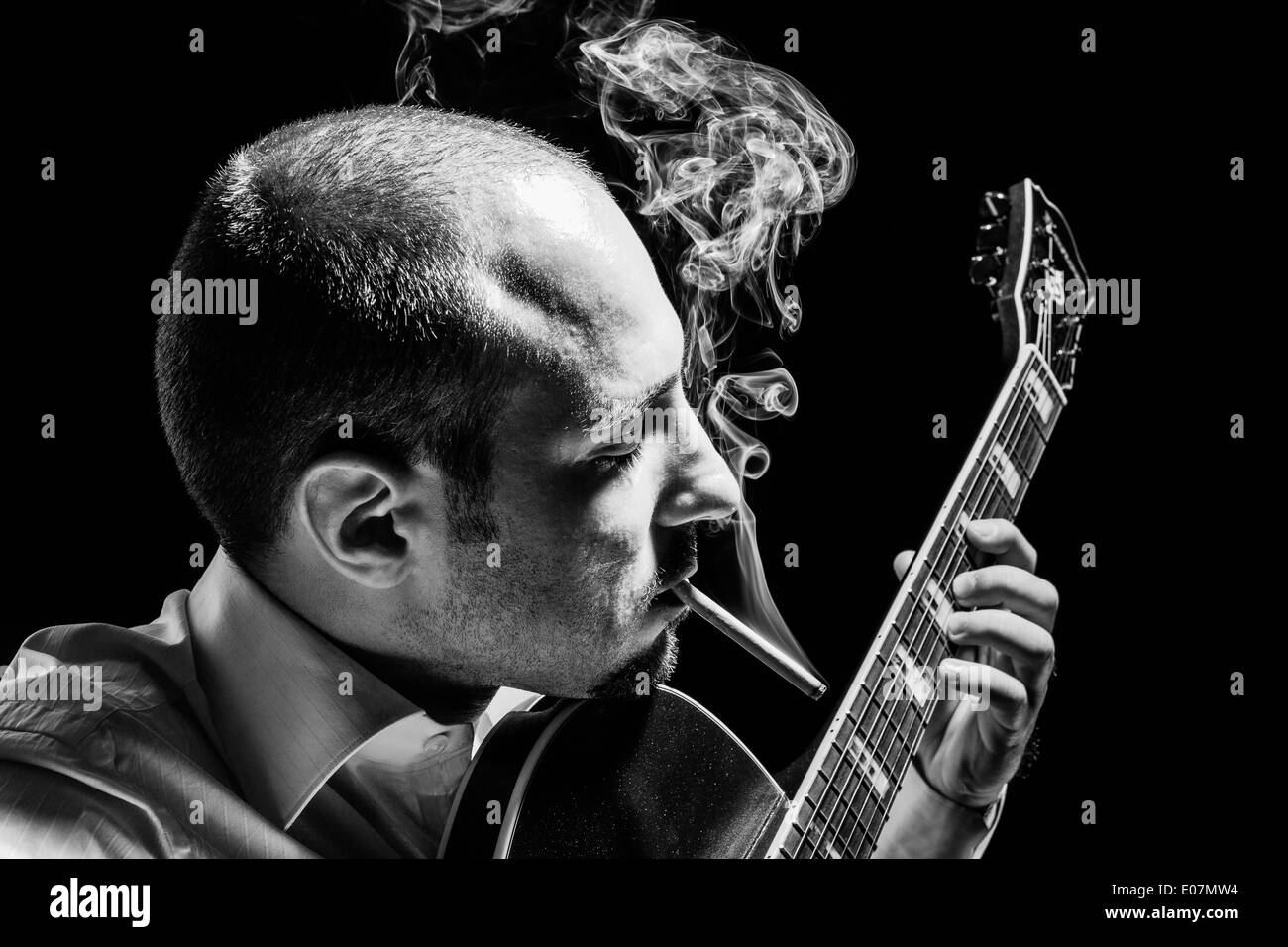 a young jazzer with a black acoustig guitar over black background Stock ...