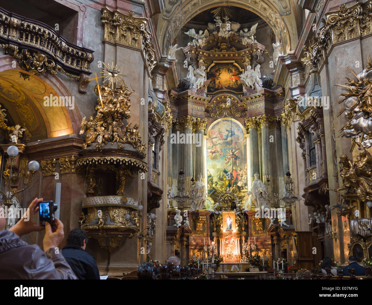 Tourist photographing the interior of Peterskirche, St. Peter's Church ...