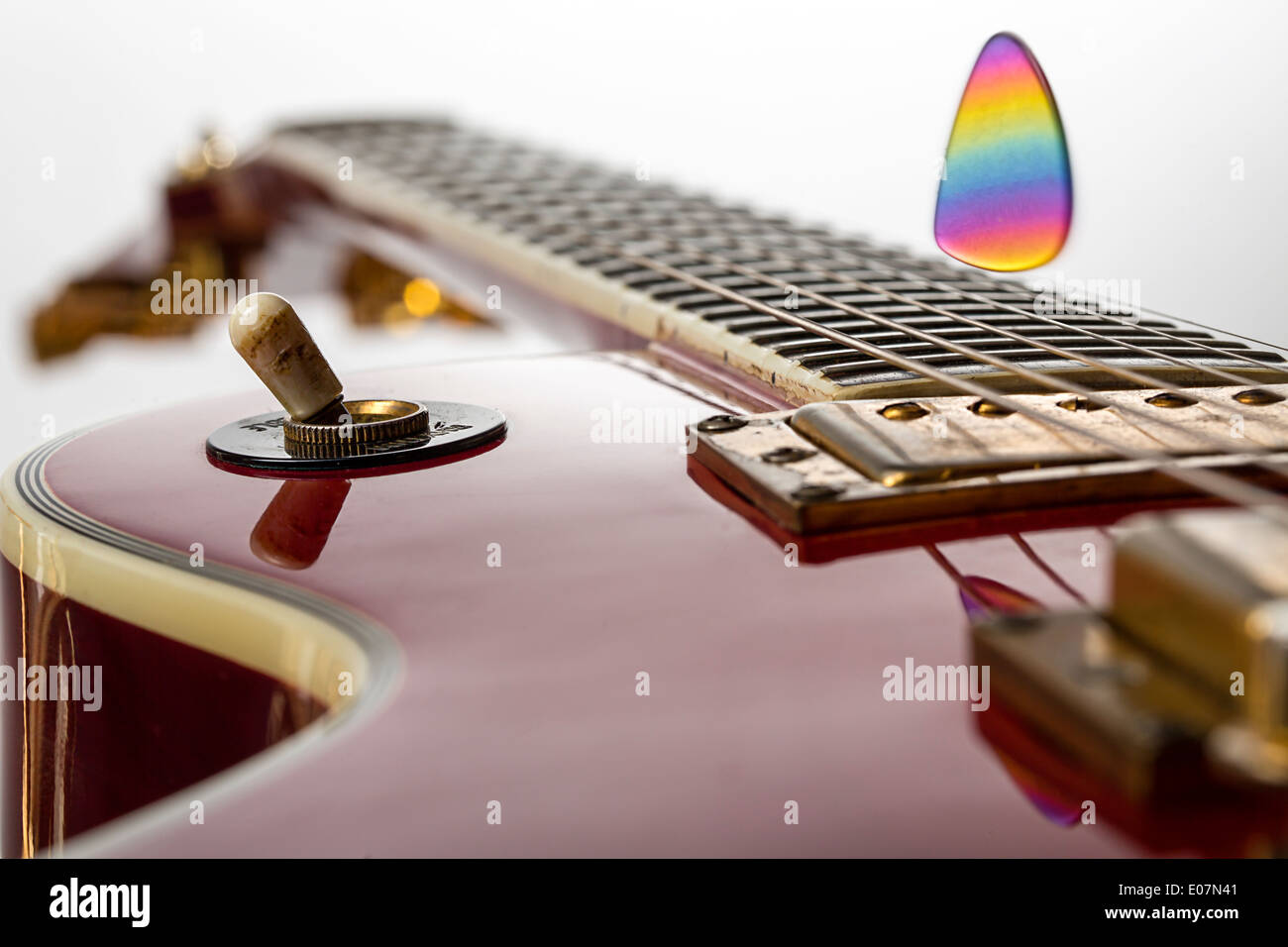 close up of a red electric guitar with flying rainbow pick Stock Photo ...