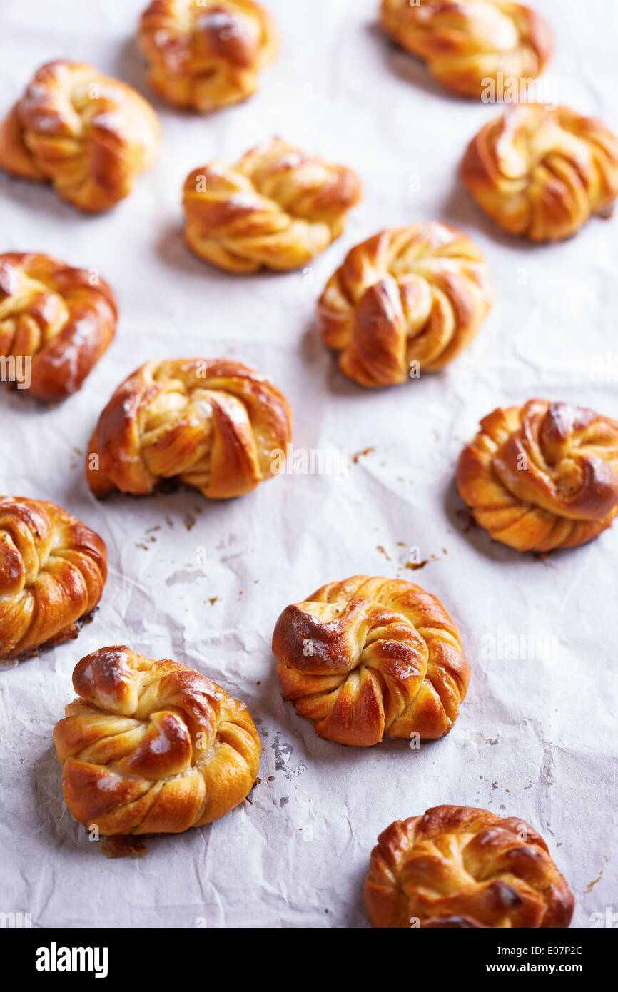 Delicious cardamom roll close-up on white oven paper Stock Photo - Alamy
