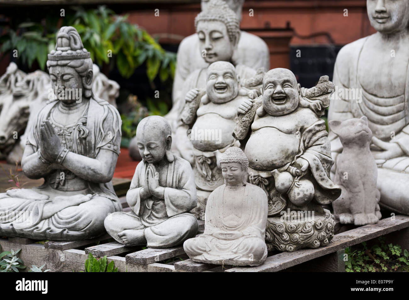 Buddha smiling and praying statues on a courtyard, London, UK Stock ...