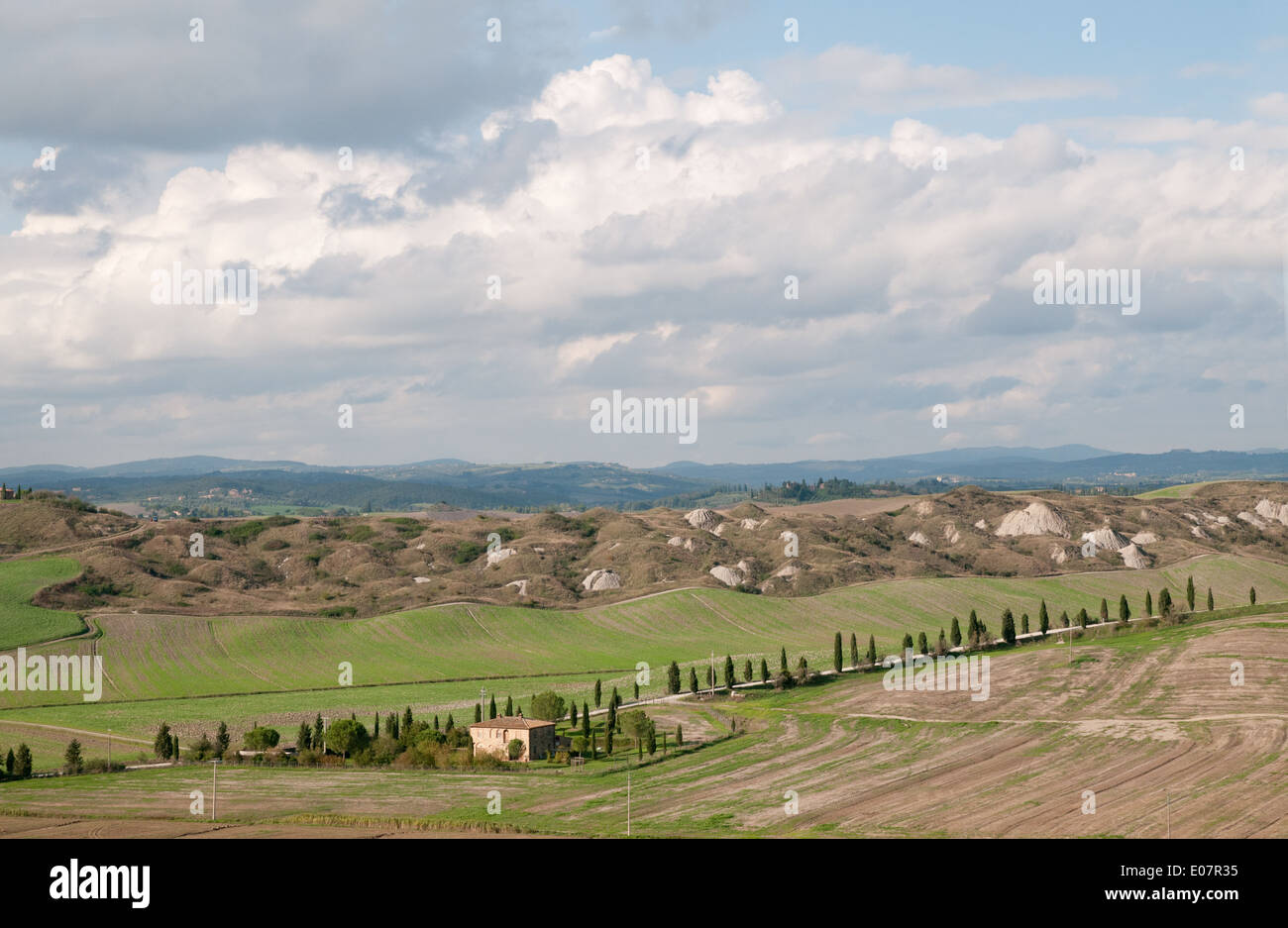 Tuscan hills with cypress tree lined road leading to 13th century ...