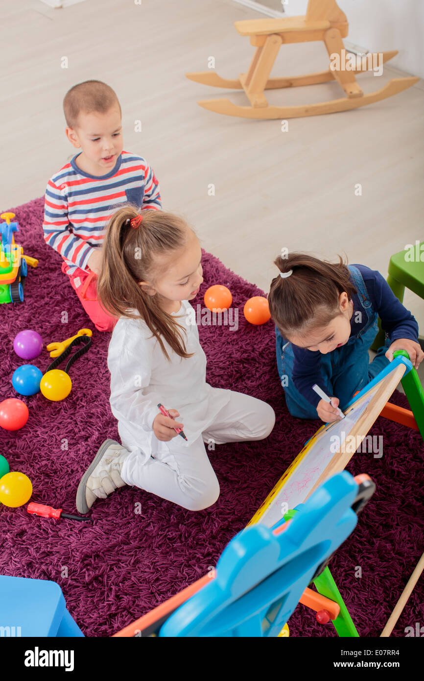Kids playing in the room Stock Photo - Alamy