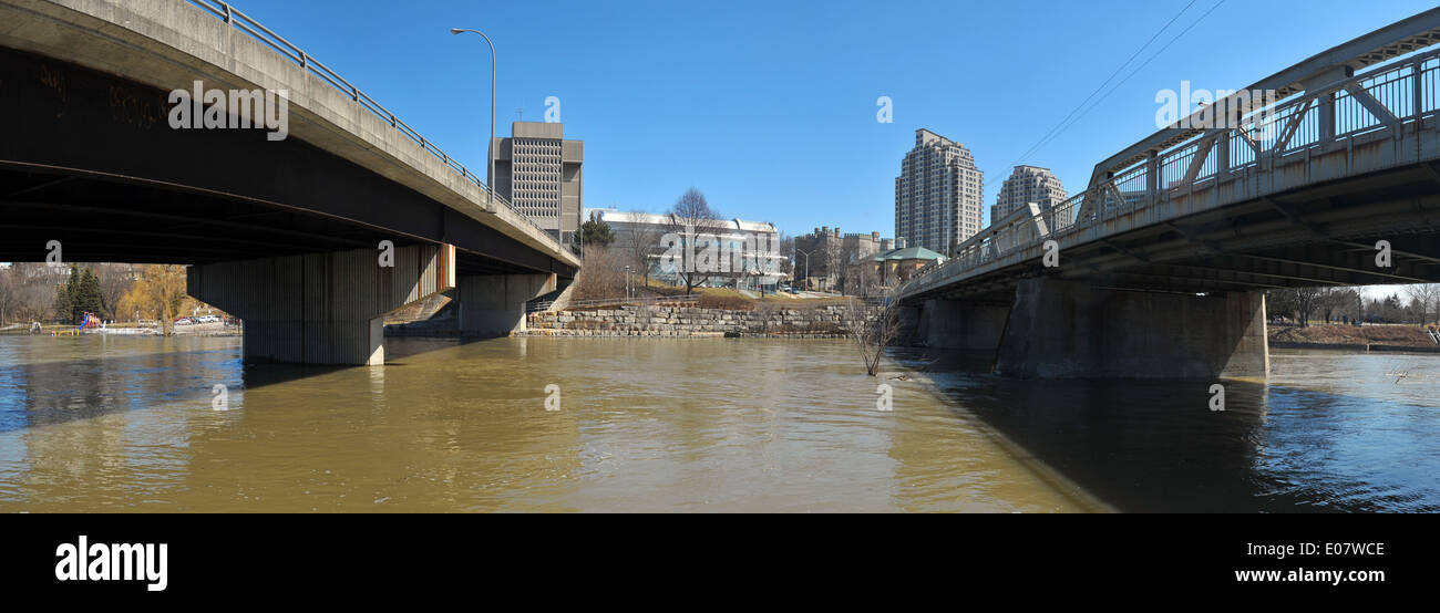 A panoramic view of two bridges crossing a river leading into a city ...
