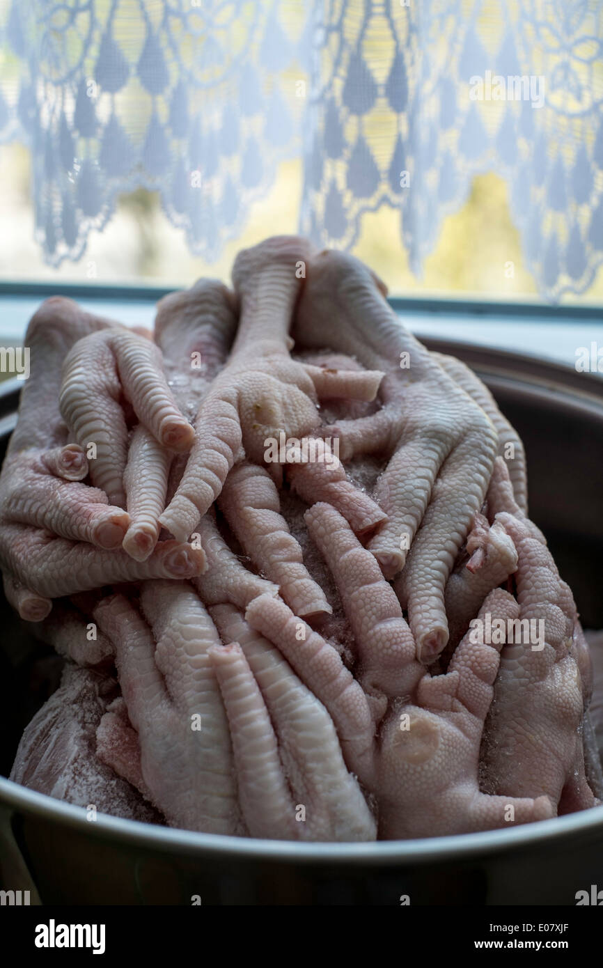 Frozen chicken feet defrosting in a pot before cooking Stock Photo - Alamy
