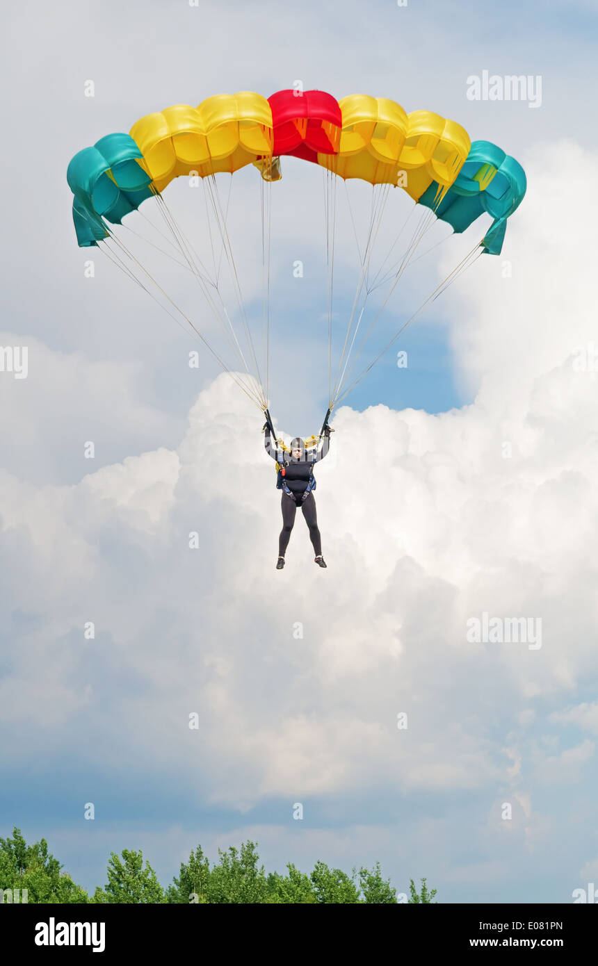 One day with parachutist in airfield. The girl skydiver lands under the ...