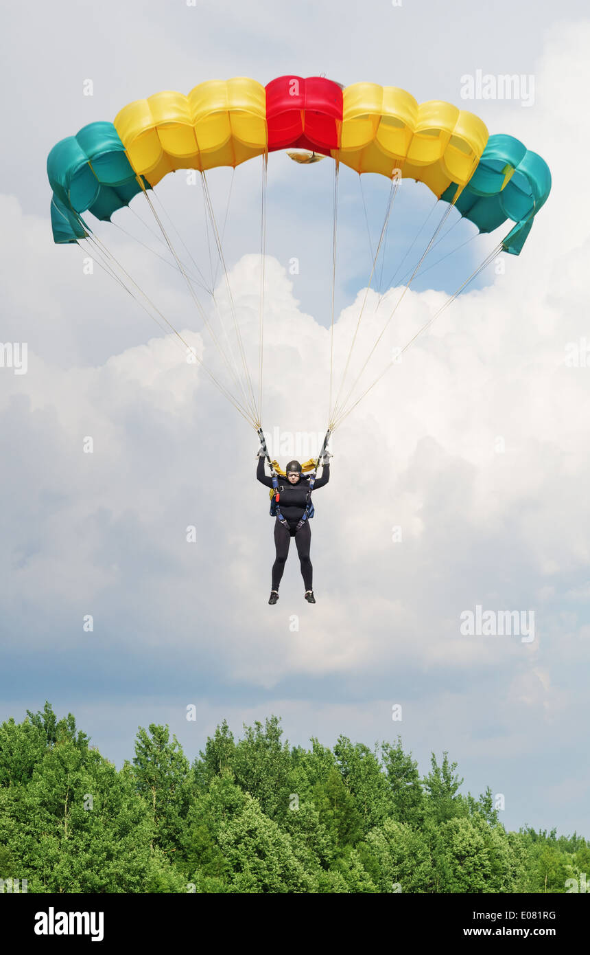 One day with parachutist in airfield. The girl skydiver lands under the ...