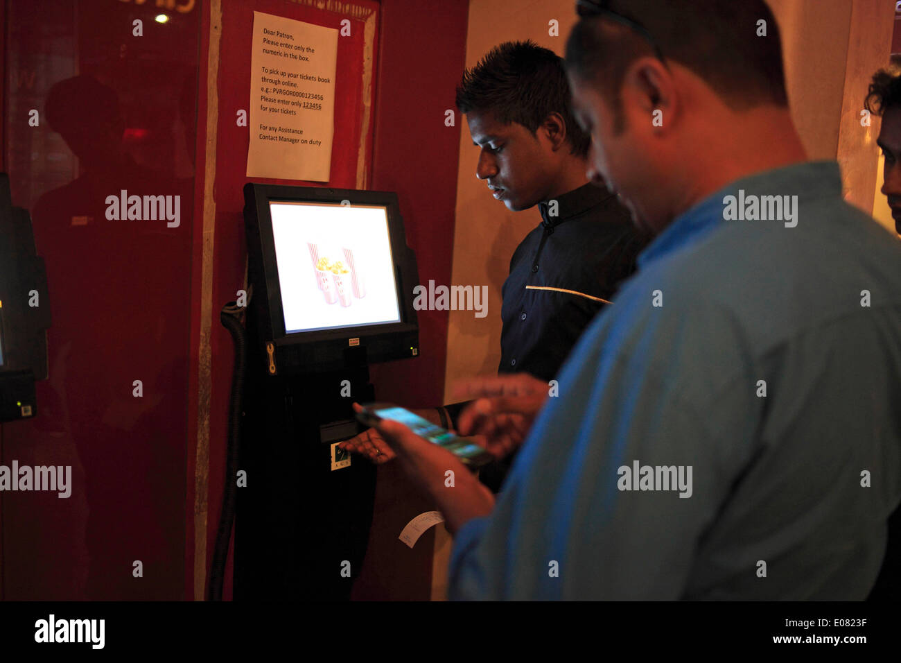 Mumbai, Maharashtra, India. 30th Apr, 2014. Staff helps a patron with ...