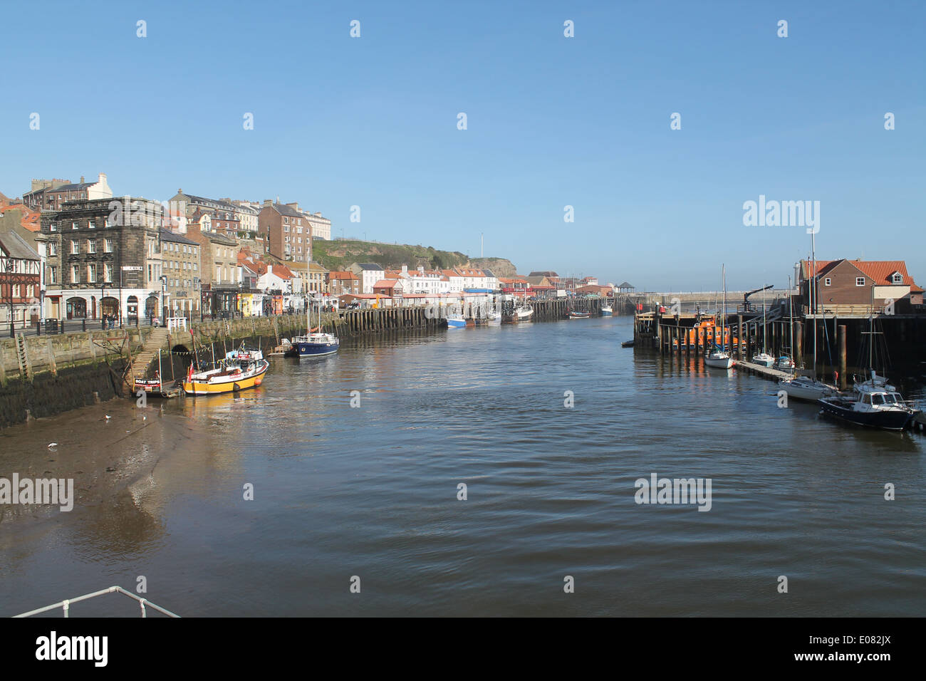 Looking towards Whitby harbour mouth from the swing bridge across ...