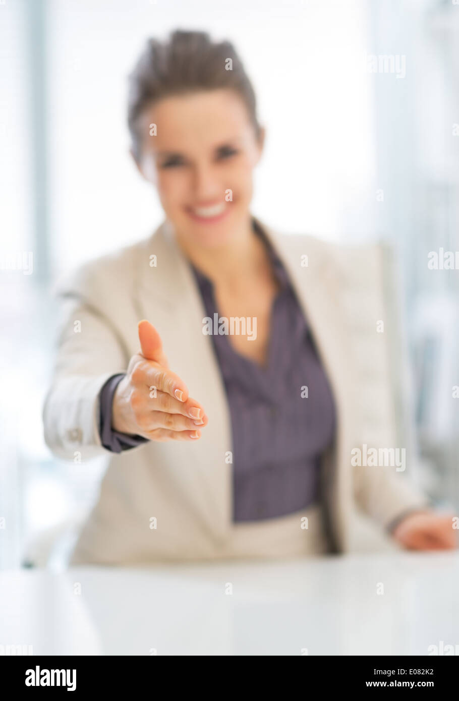 Confident businesswoman stretching hand hi-res stock photography and ...