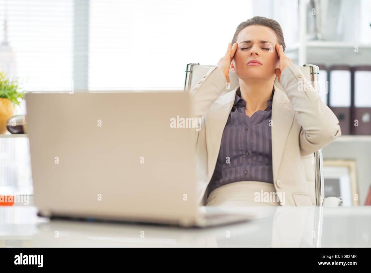 Stressed business woman at work Stock Photo - Alamy