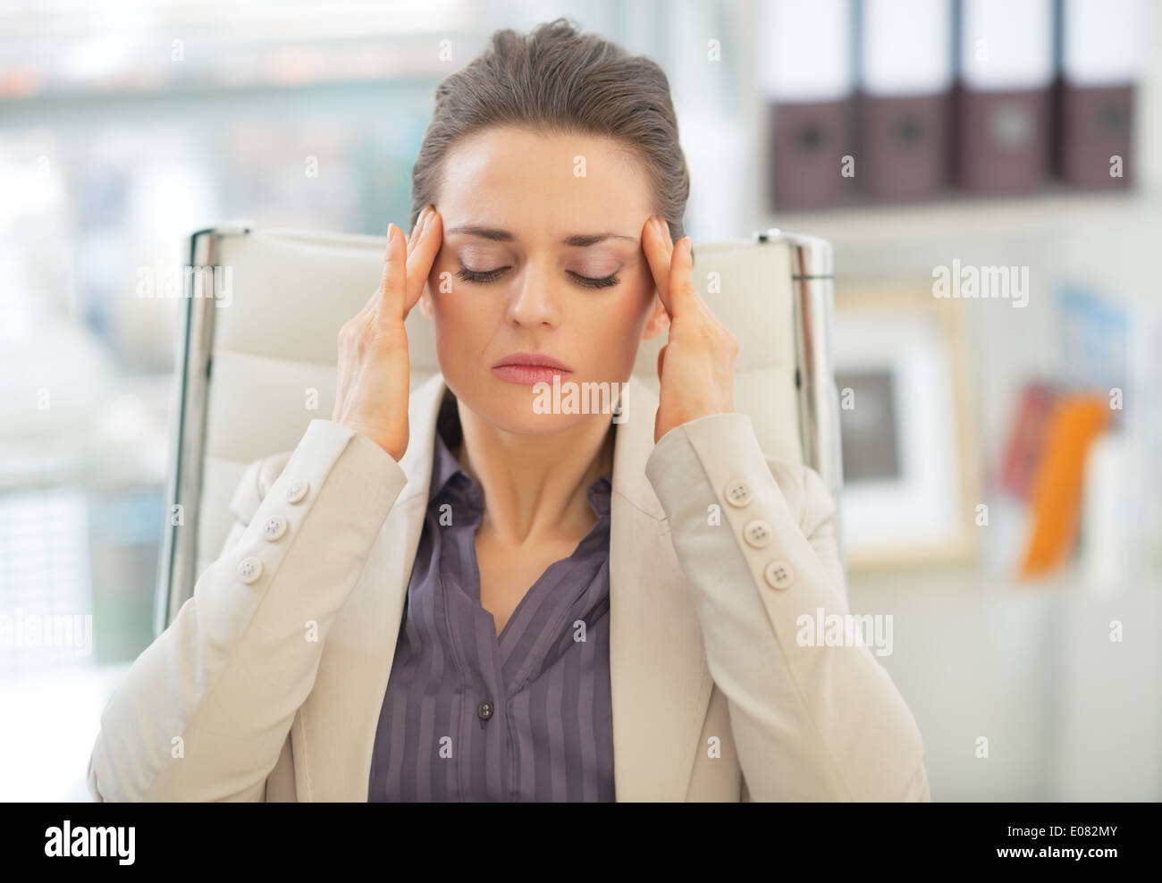Stressed business woman in office Stock Photo - Alamy
