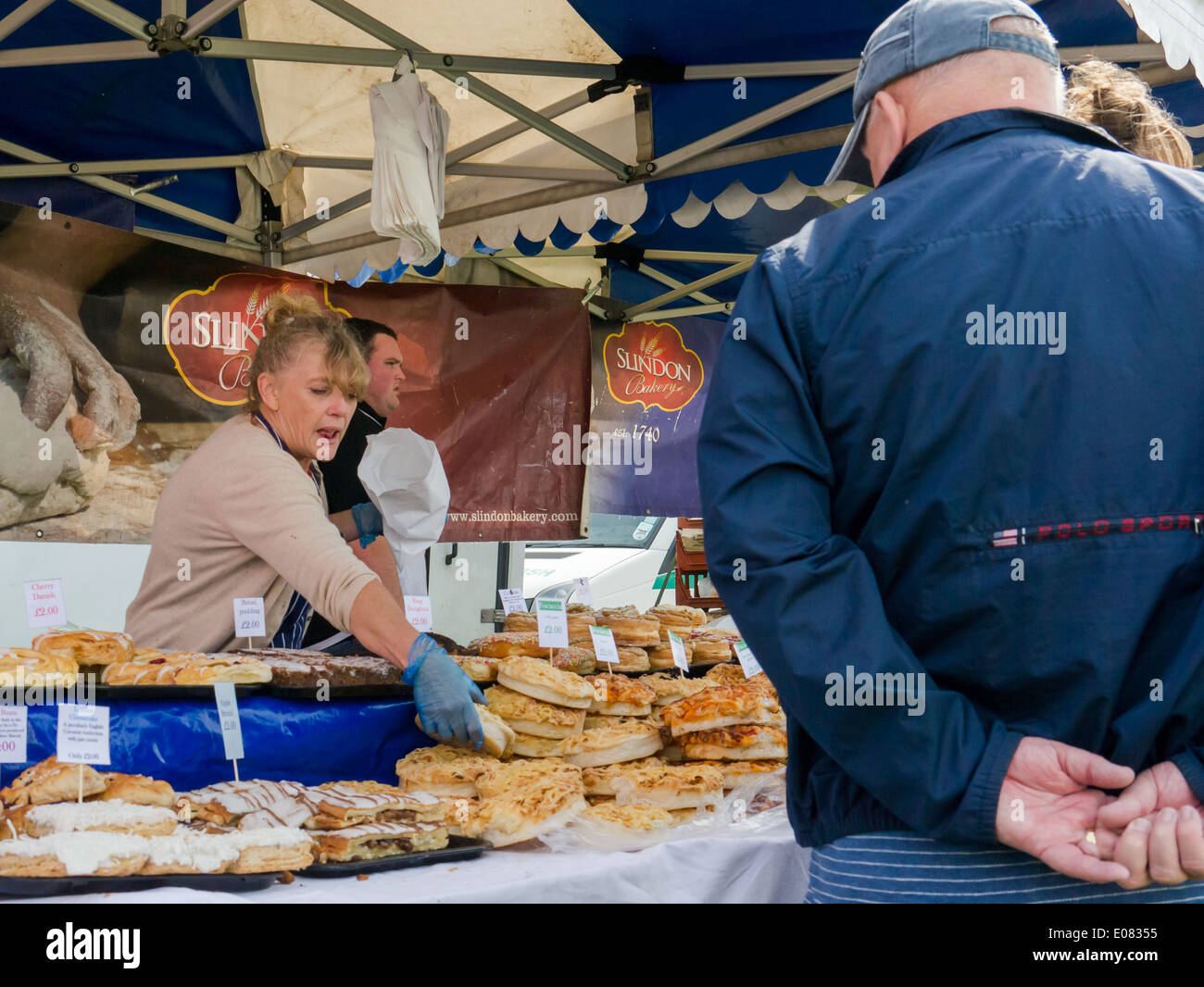 A customer buying Pastries from a market stall Stock Photo - Alamy